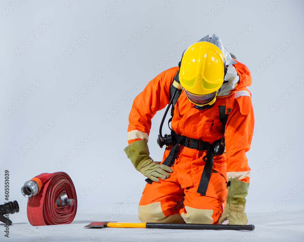 Professional firefighter is sitting and kneeling down looking at the ...
