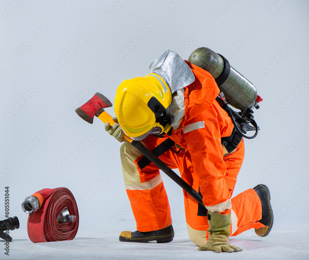 Professional firefighter assumes a kneeling position his body grounded ...