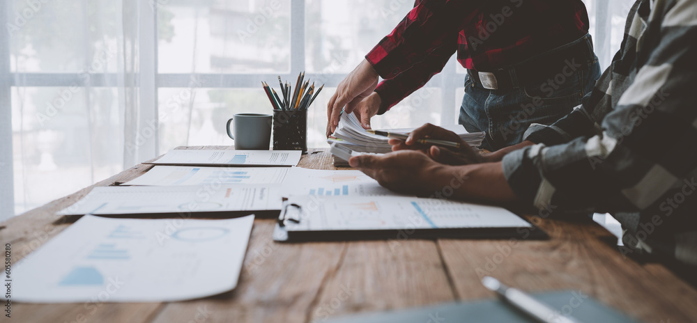 Team work process, business team using calculator to calculate figures ...