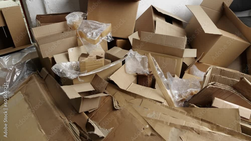 Cardboard and film waste. Used shipping boxes. Sheets or stiff multi ...