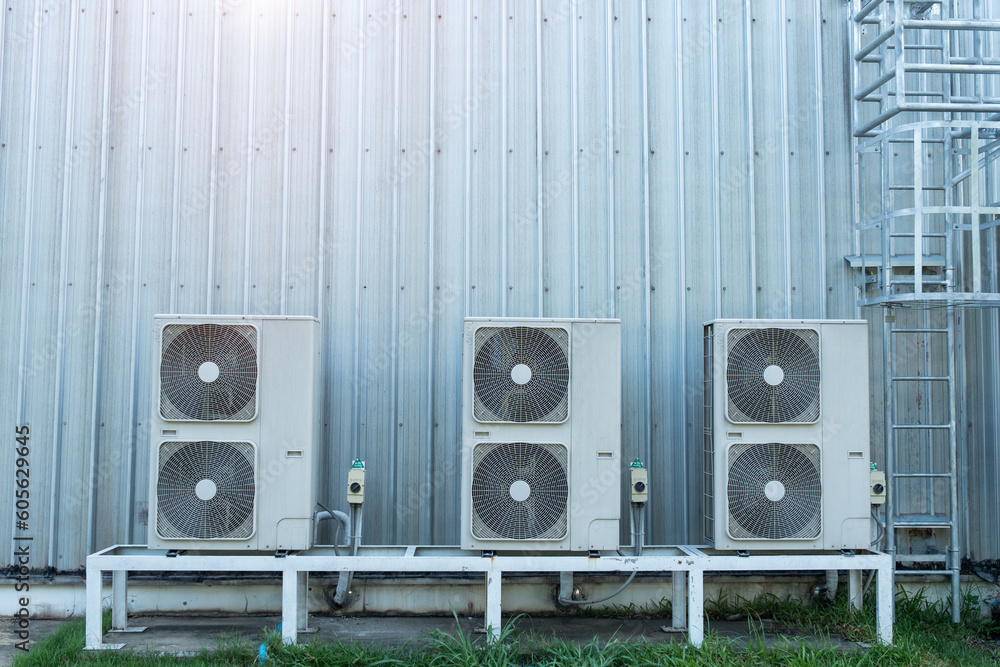 Condenser unit or compressor on roof of industrial plant building with ...