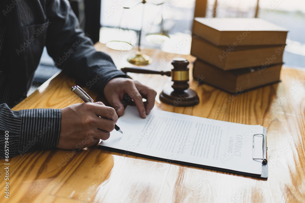 Lawyer working in a law office reading agreement contract documents and ...