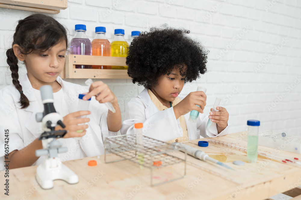 Group of child girl learning science and analyse liquid in the ...