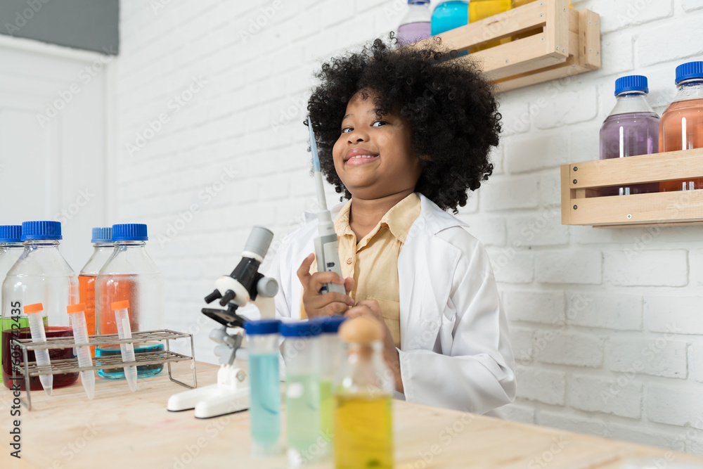 Child girl learning science and analyse liquid in the laboratory at ...