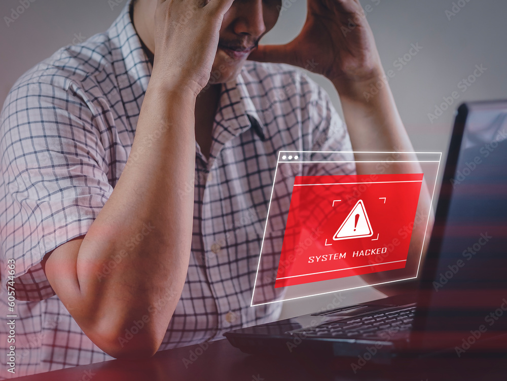 Hack notification system. User is using computer with warning triangle sign for error ...