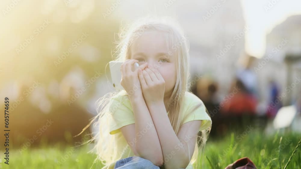 Portrait of cute little blond girl child having phone call conversation ...