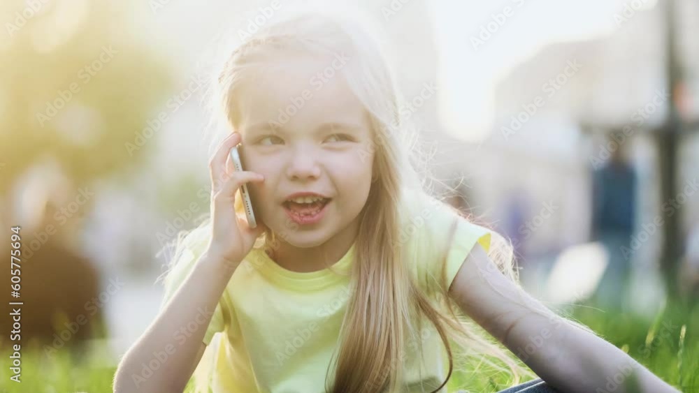 Portrait of cute little blond girl child having phone call conversation ...