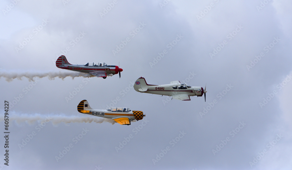 Vintage Yakovlev Yak 18T ,Yak 50 and 52 in flight against blue sky ...