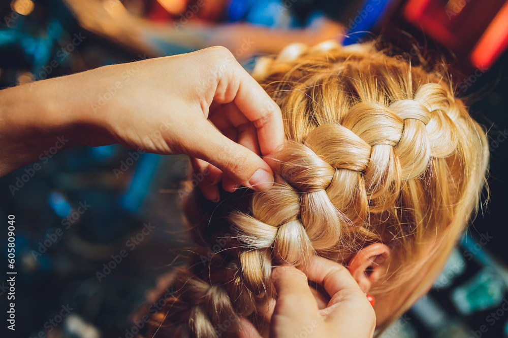 Process of braiding the master weaves braids on her head blond little ...