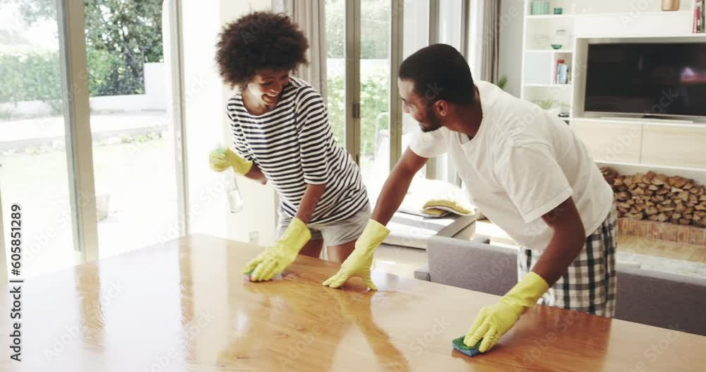 Housekeeping, detergent and couple cleaning the table together while ...