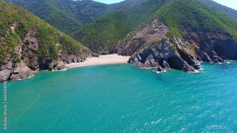 small beach in a heavenly cove of fine white sand between two mountains ...