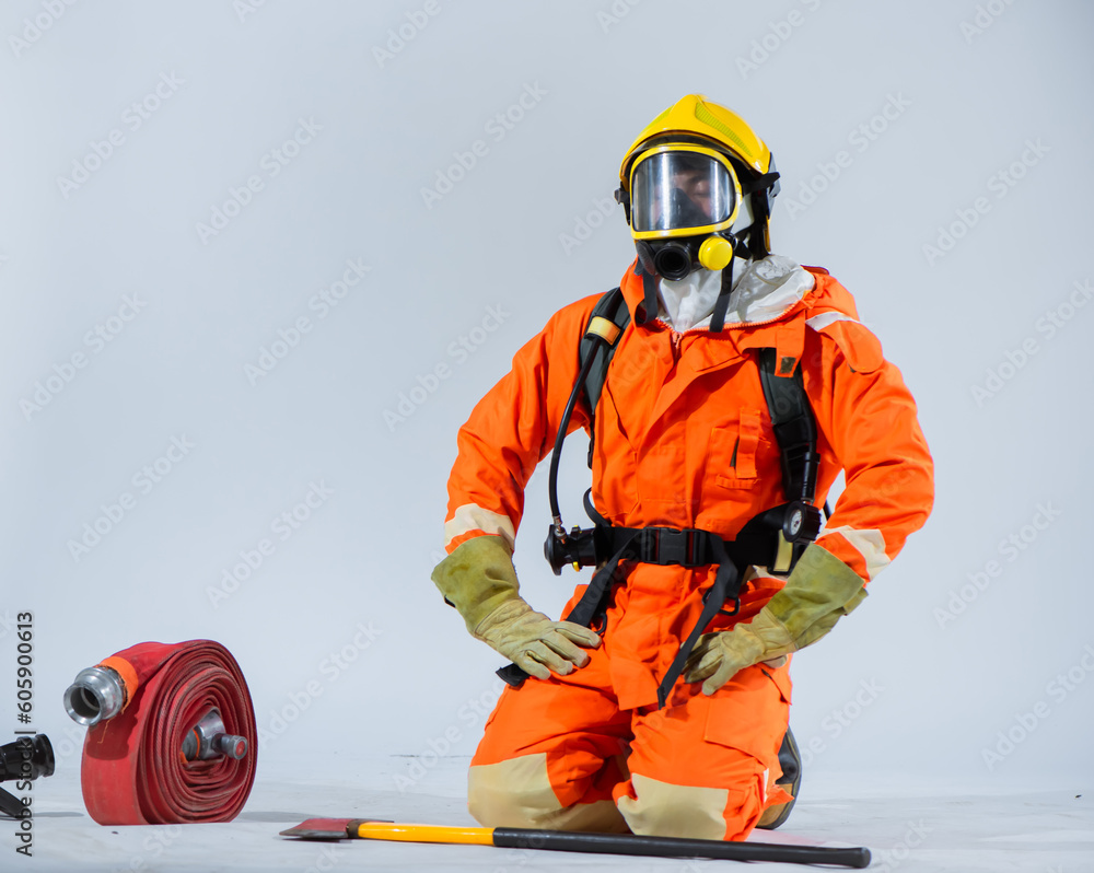 Professional firefighter is sitting and kneeling down placing both ...