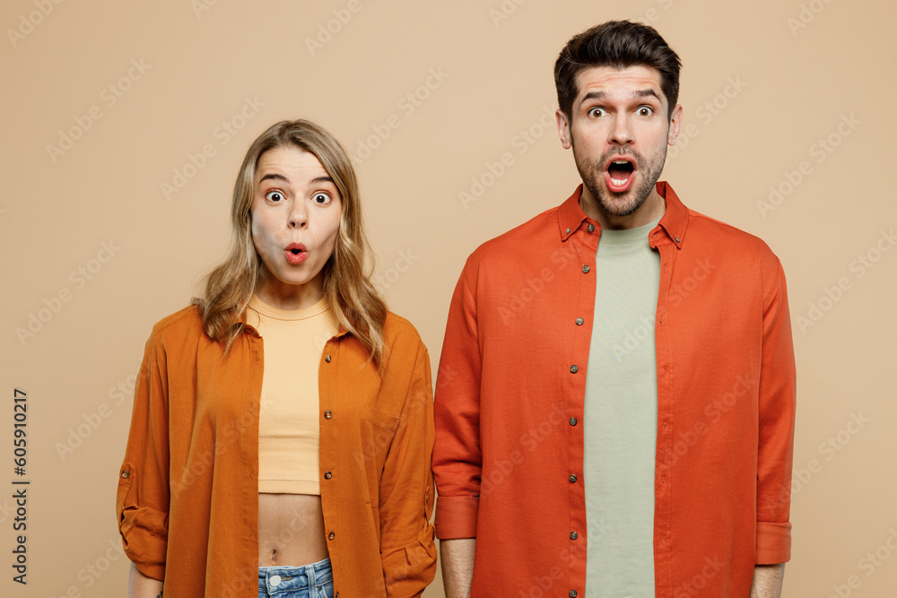 Young shocked surprised amazed couple two friends family man woman wear ...