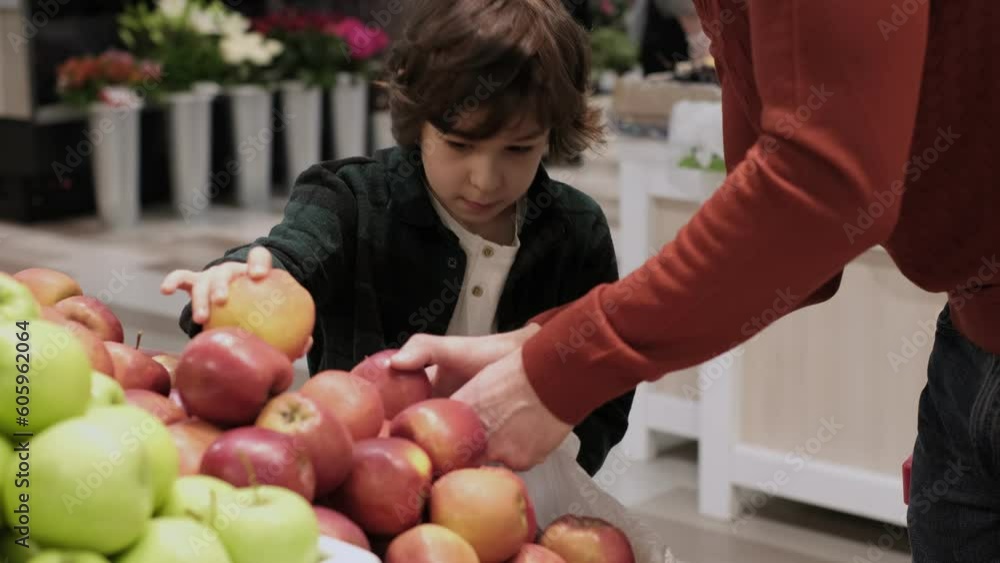 father and his son working together to select freshest and tastiest ...