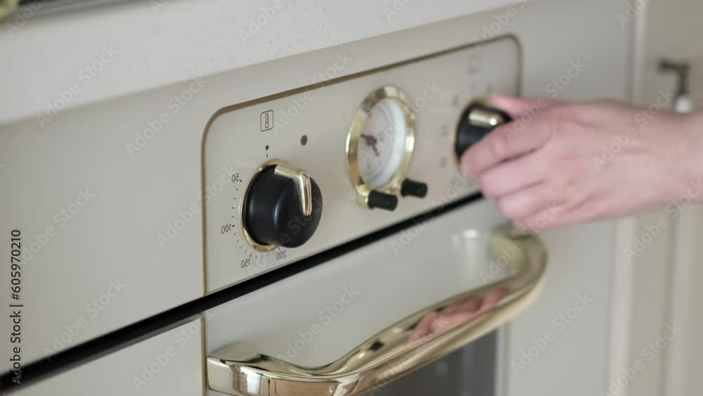detailed frame of woman's hand deftly operating temperature regulator ...