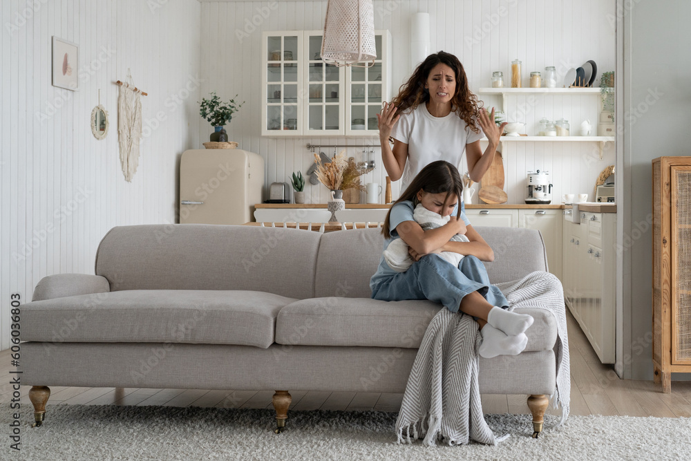 Angry parent, mother yelling at teen girl daughter while arguing at home. Problems between ...