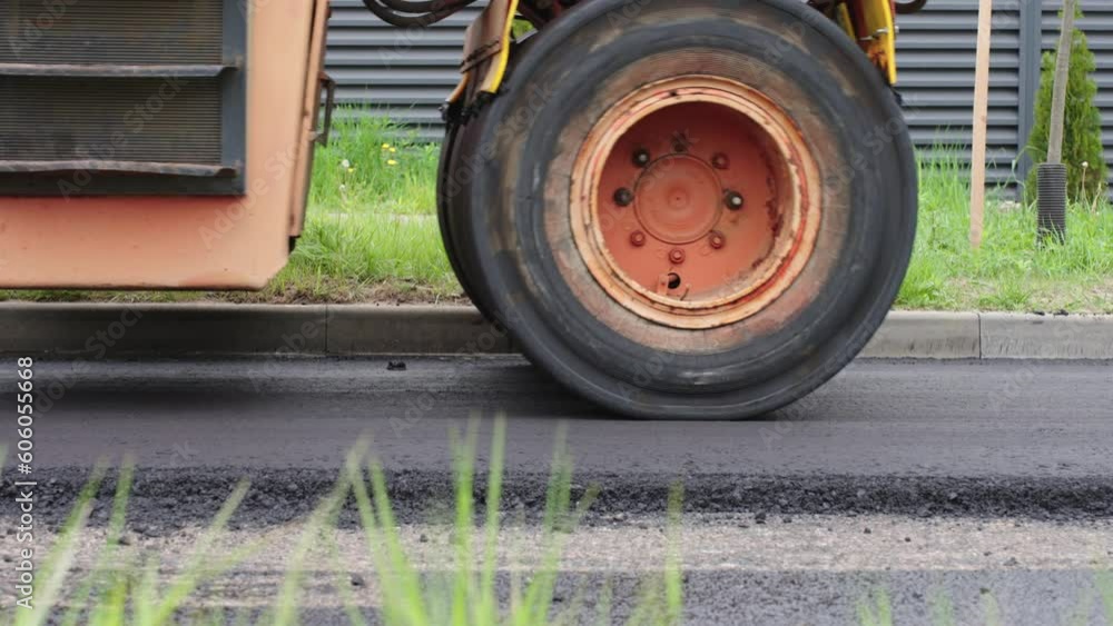 The process of laying asphalt on city street with a paving machine ...