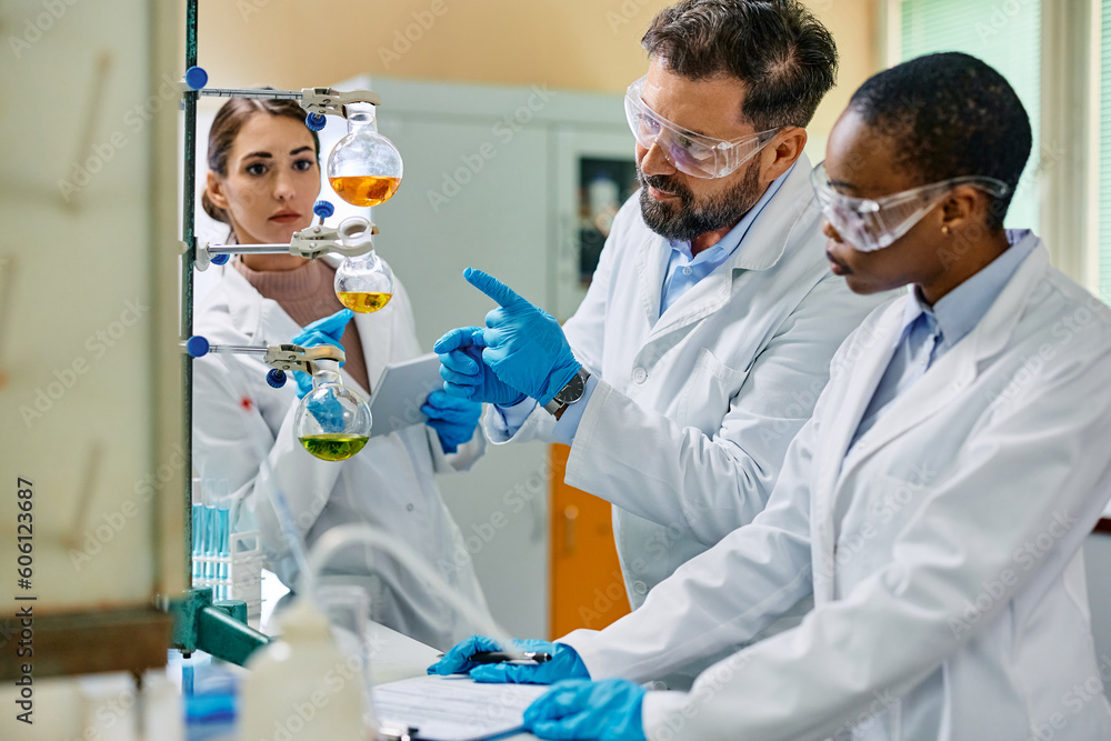 Multiracial team of microbiologists working on new scientific research ...