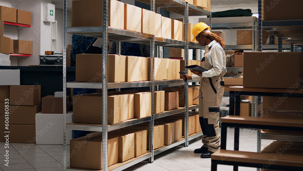 Young woman scanning barcodes on packages to work on stock logistics ...