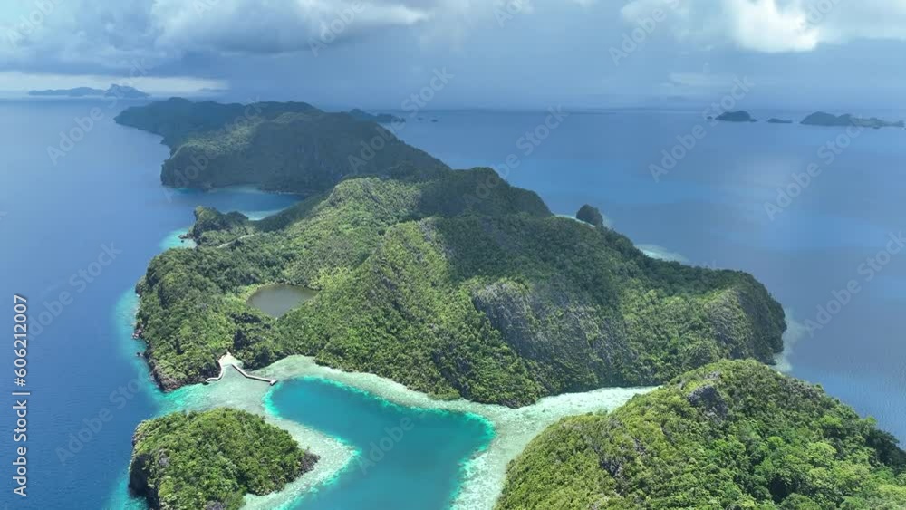 A heart-shaped lagoon is surrounded by limestone islands in Raja Ampat ...