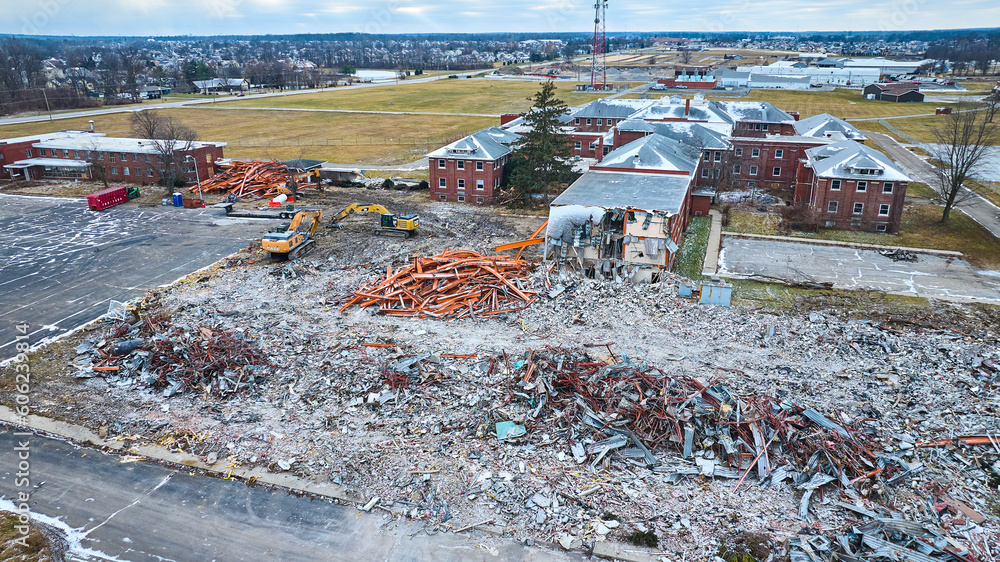 Drone aerial of deconstruction site of old abandoned hospital building ...