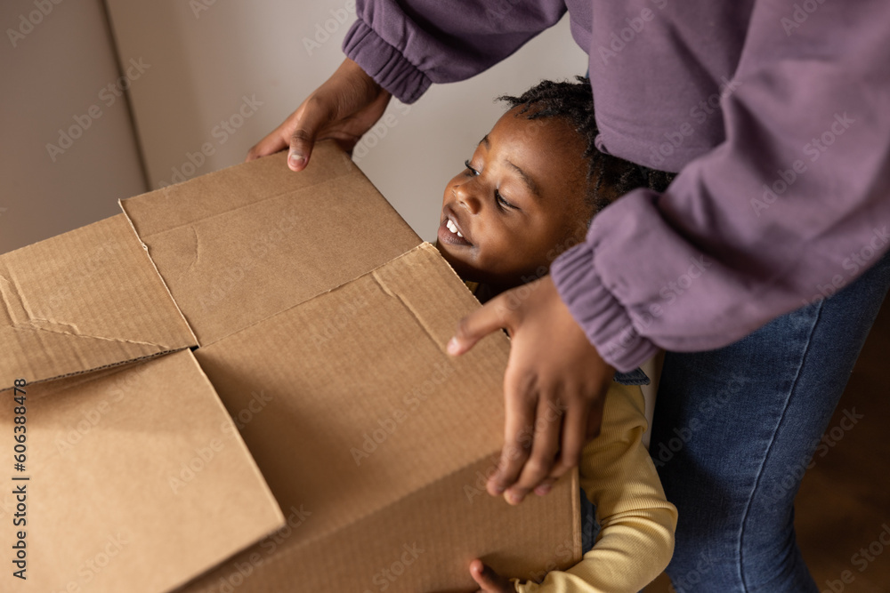 Girl helping carrying a large box as they move to a new home Stock ...