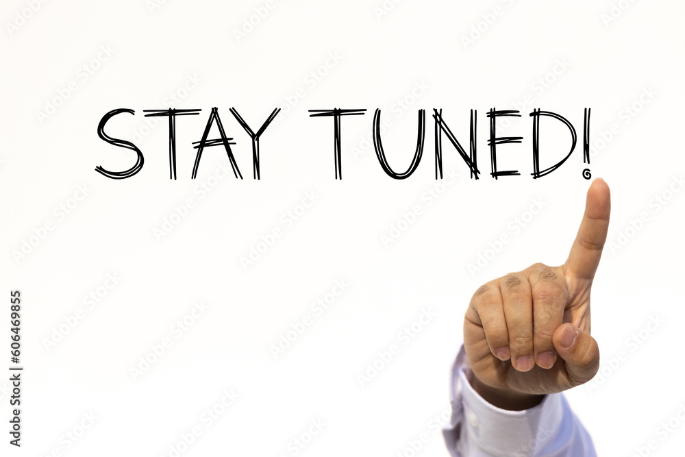 Stay tuned text on white wall background with businessman's finger ...