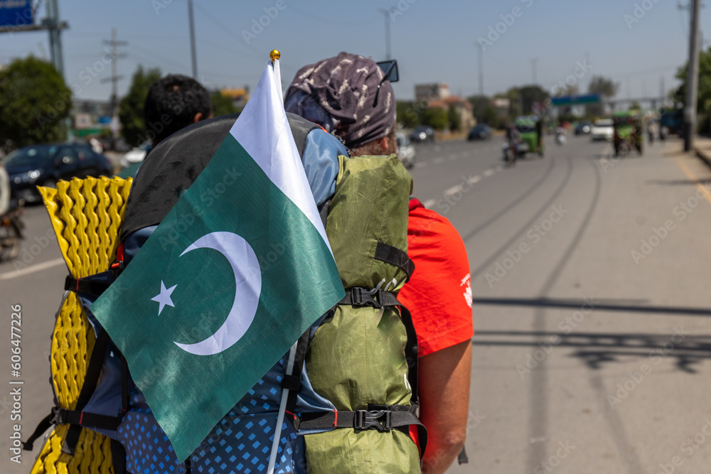 Backpacker walking in Pakistan with a pakistani flag on his backpack ...