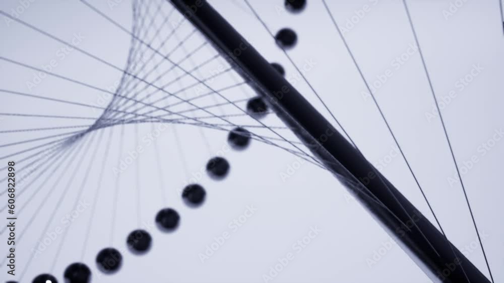 abstract modern animation of metal balls seeded on twine and spinning ...