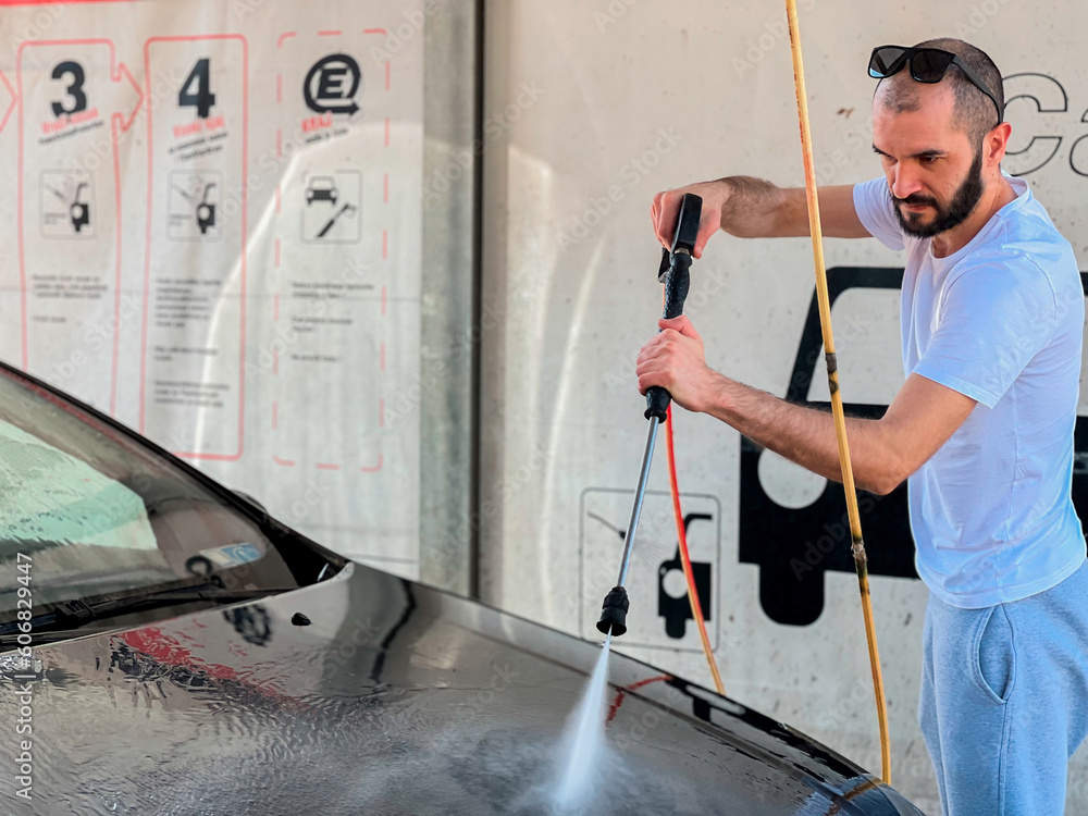 Hand washing a car in a car wash, revitalizing shine and impeccable ...