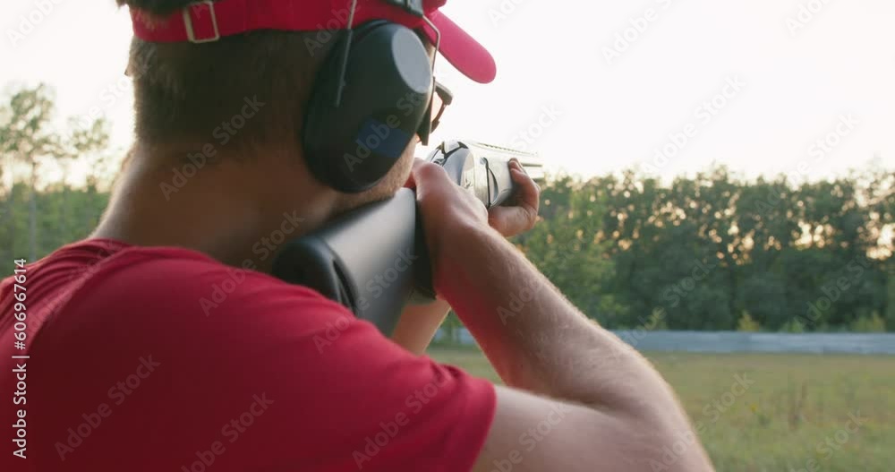 Stockvideon Skeet Shooting Sport. young adult man is shooting during a ...