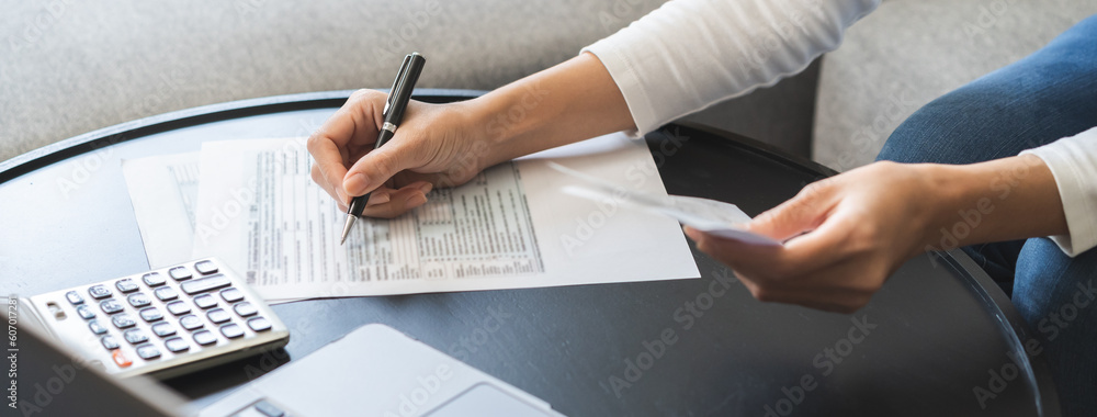 Deduction planning concept. Asian young woman hand using calculator to ...