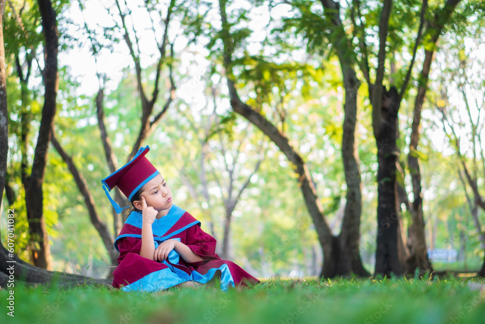 Asian child little graduate wears gown and degree hat or kid girl ...