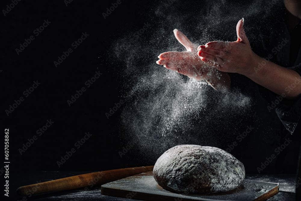 woman chef hand clap with splash of white flour and black background ...