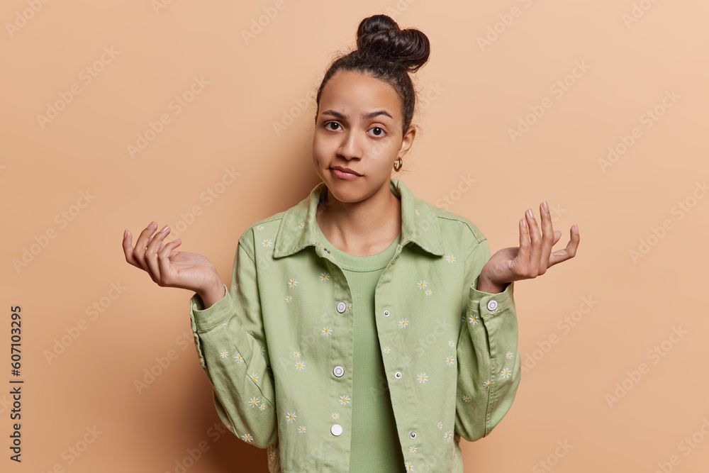 Reluctant indecisive lovely Latin teenage girl dressed in green shirt ...