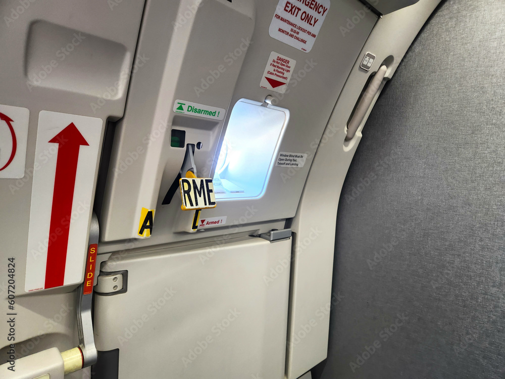 Airplane exit hatch with warning signs, unarmed Stock Photo | Adobe Stock