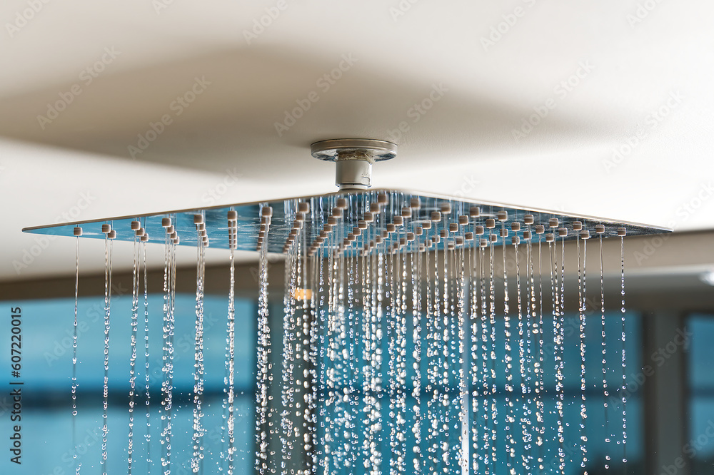 Water flows from the tropical shower. Large water consumption. Chrome ...