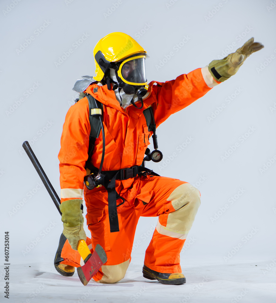 Professional firefighter is sitting and kneeling down holding an iron ...