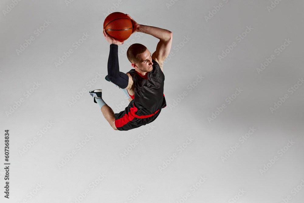 Dynamic image of concentrated young man, basketball player throwing all ...