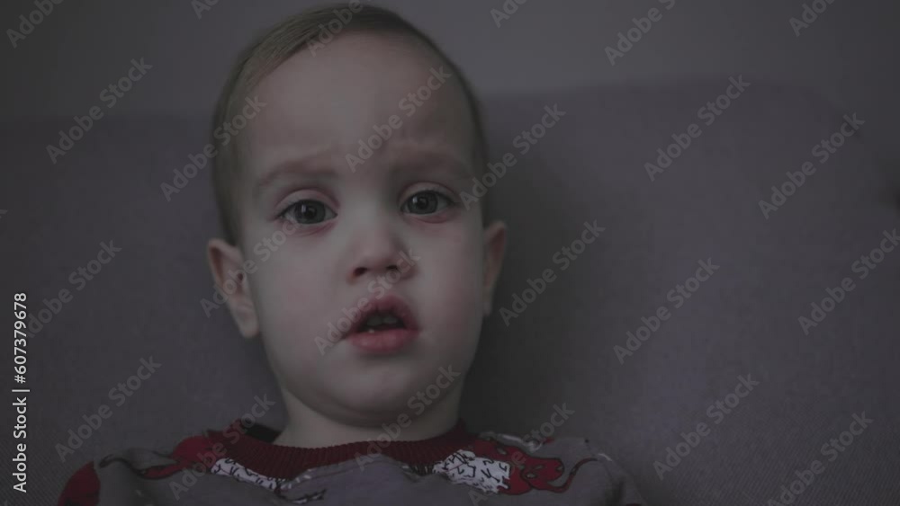 toddler with high temperature sitting sofa living room gray pajamas ...