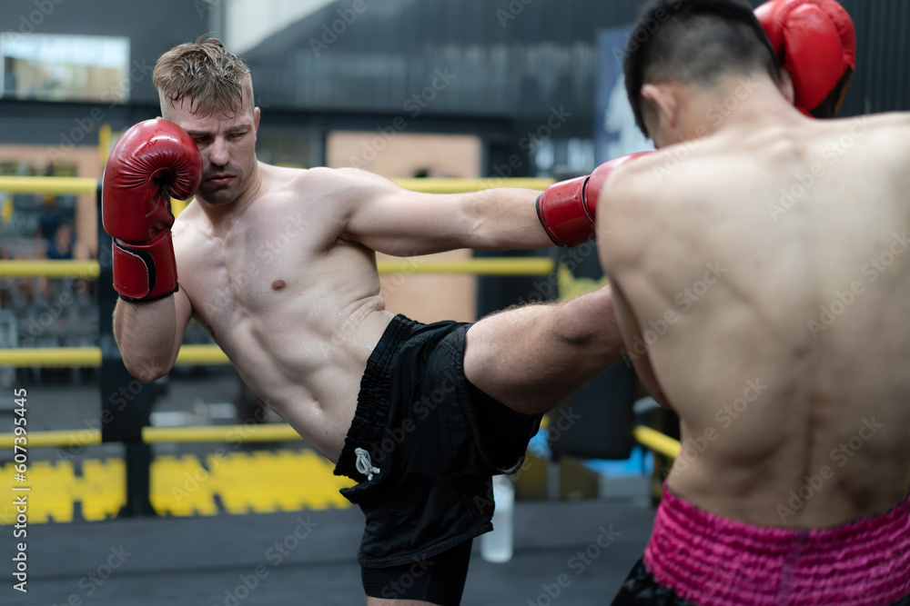 Two male athlete boxing competition in ring. Diverse ethnic men kick ...