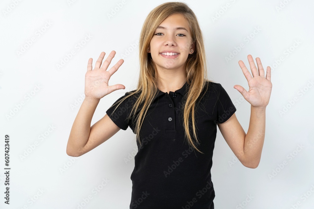 beautiful teen girl wearing black dress over white studio background ...