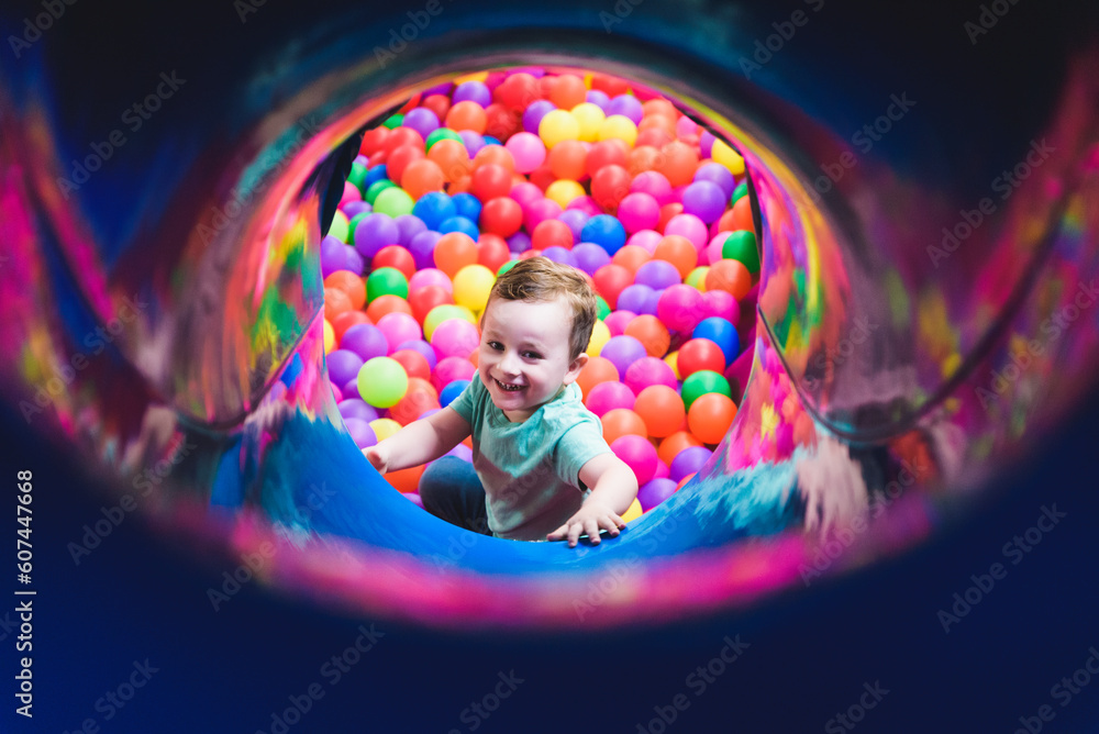 Child on the playground with colored plastic balls Stock Photo | Adobe ...