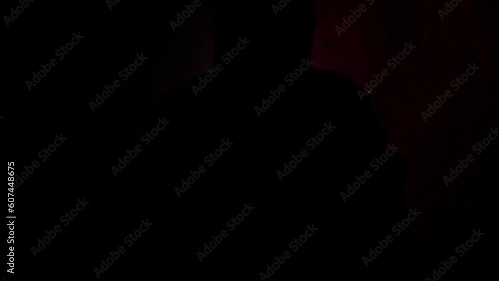 A man sits at a table, removes the mask of an evil creature. Under the ...