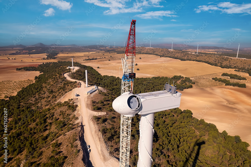 Aerial Top View of the Installation of a wind turbine farm. Team of ...