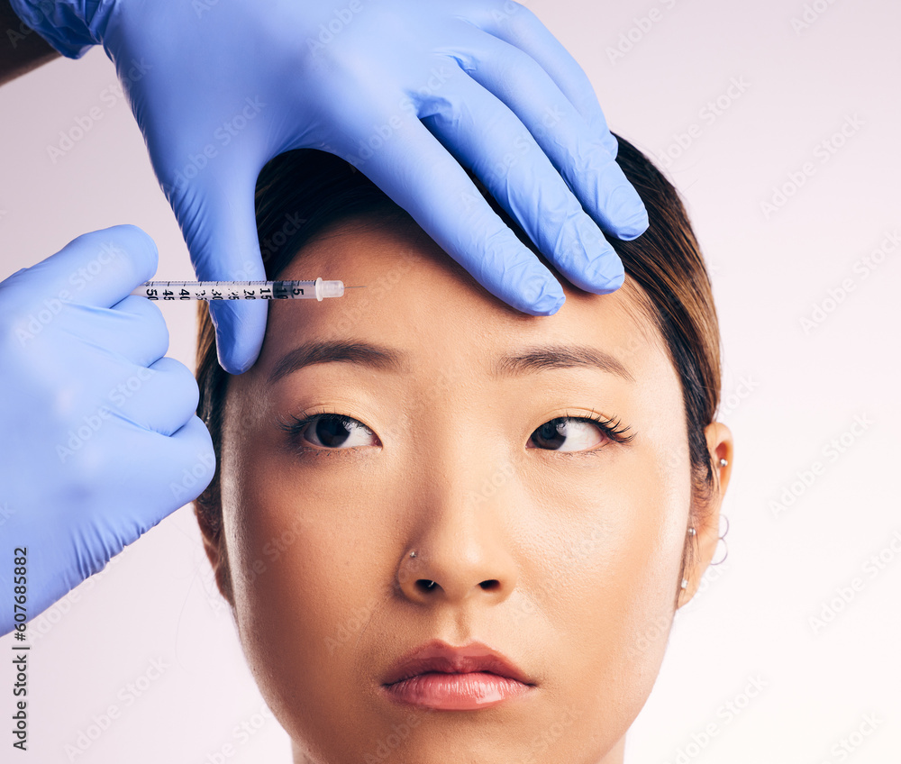Forehead injection, face skincare and Asian woman in studio isolated on a white background ...