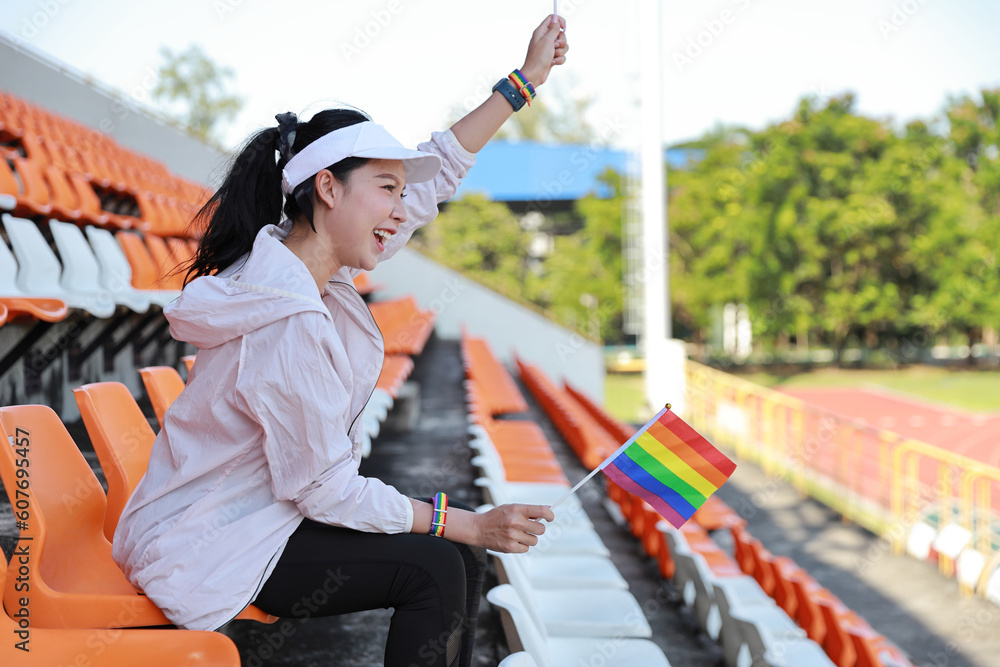 Happy and excited young female asian transgender LGBT sport fan ...