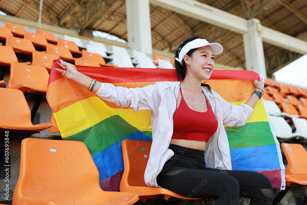 Happy and excited young female asian transgender LGBT sport fan ...
