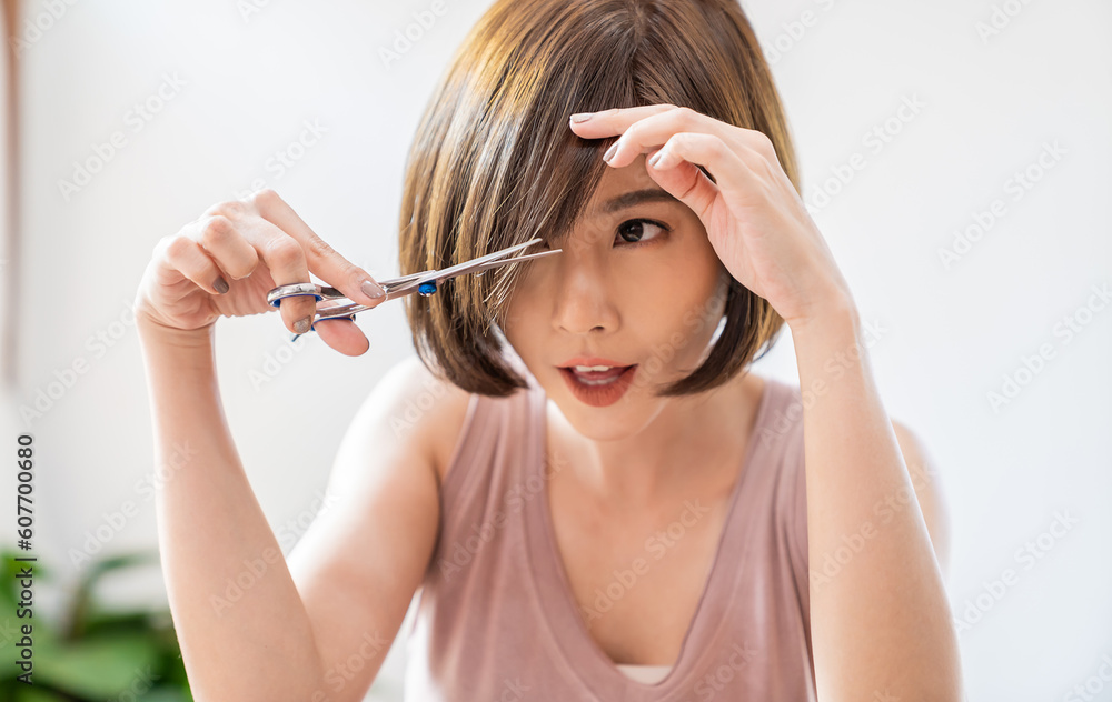 Portrait of beauty asian woman has scissors hand cutting hair during ...