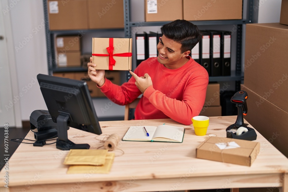 Young hispanic man ecommerce business worker having video call holding ...